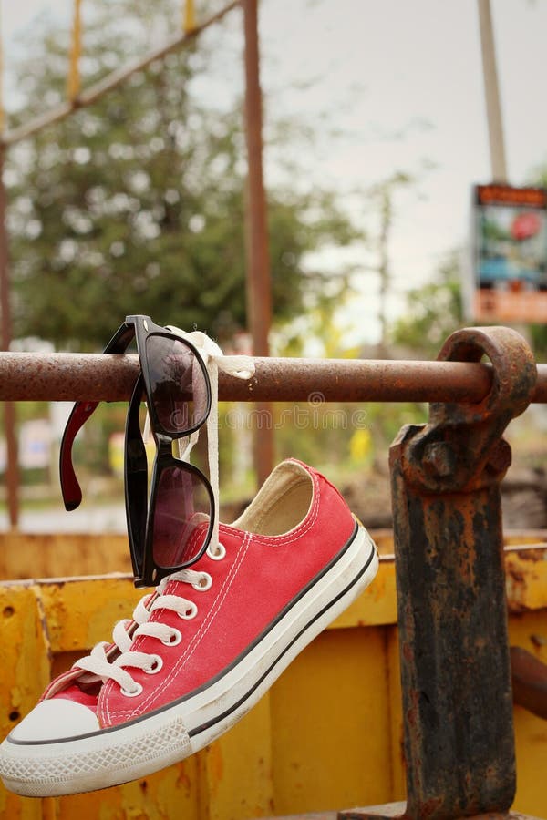 Red Shoes with Sunglasses Hanging on Steel. Stock Photo - Image of path ...