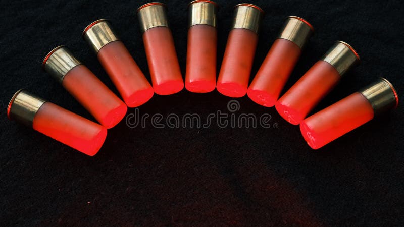 Red Shotgun Shells on a Black Surface. Ammunition for 12 Gauge ...