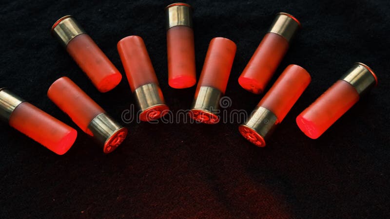 Red Shotgun Shells on a Black Surface. Ammunition for 12 Gauge ...