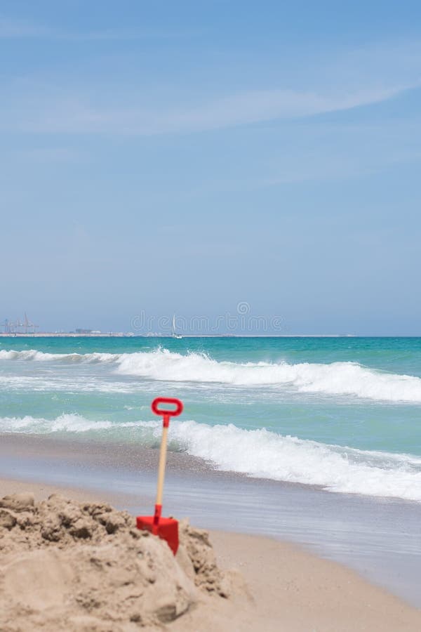 Red shovel in the beach. stock photo. Image of shore - 96898260