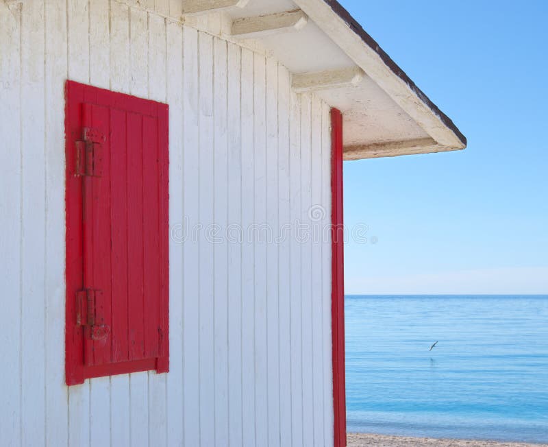 White Beach Hut with Red Shutter, Blue Sea and Sky. Stock Image - Image ...