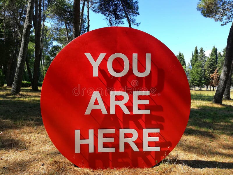 Red sign you are here stock photo. Image of mapping - 193246158