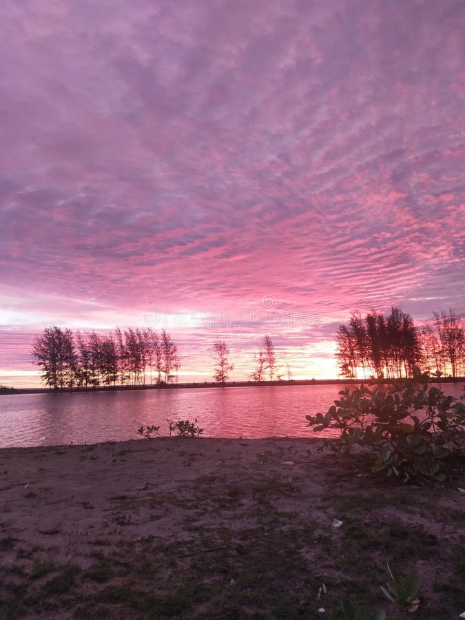 Red sky on the beach stock photo. Image of sunrise, beach - 250221482