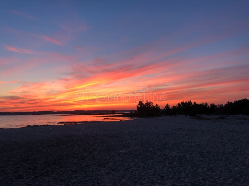 Red sky stock photo. Image of calm, beach, sunset - 163135534