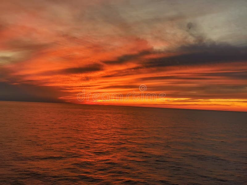 Red sky at sea stock image. Image of twilight, cloudy - 204449857