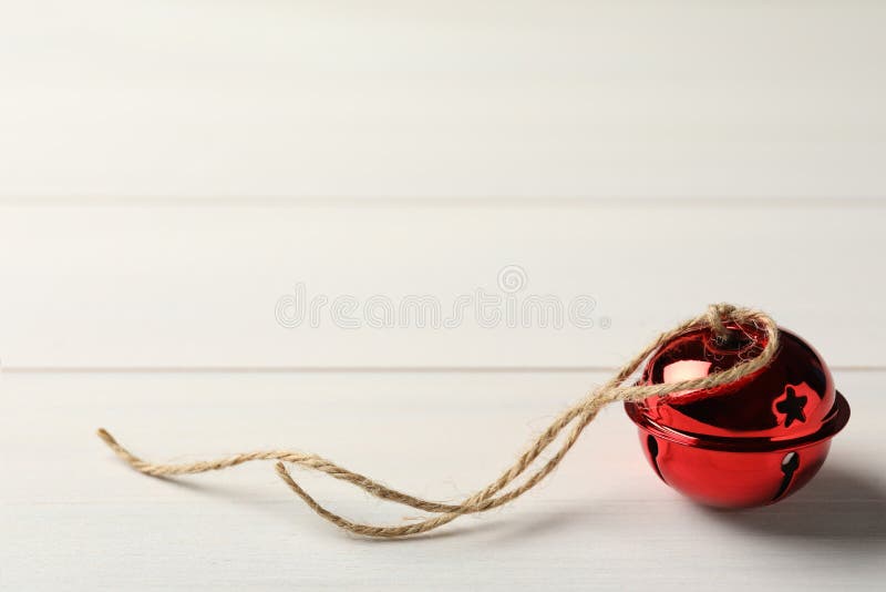 Red Sleigh Bell with Rope on White Wooden Table. Space for Text Stock ...
