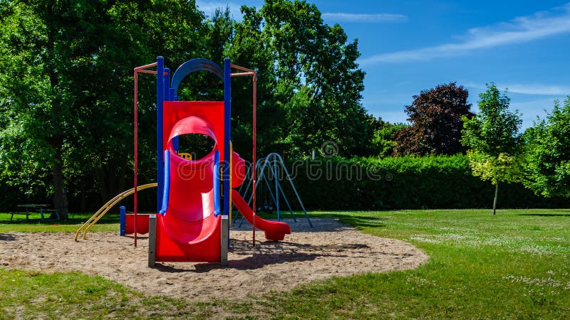 Red Slide and Playground Structure in a Public Park Stock Photo - Image ...