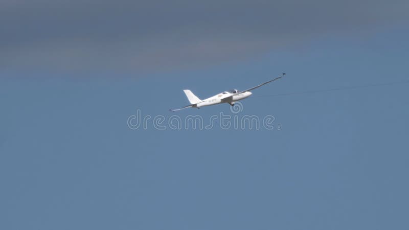 Red Small Sport Plane Flying in the Sky Pulls on a Rope the Glider ...