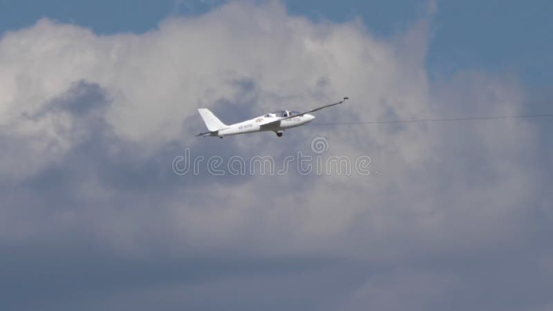 Red Small Sport Plane Flying in the Sky Pulls on a Rope the Glider ...