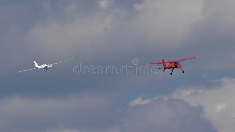 Red Small Sport Plane Flying in the Sky Pulls on a Rope the Glider ...
