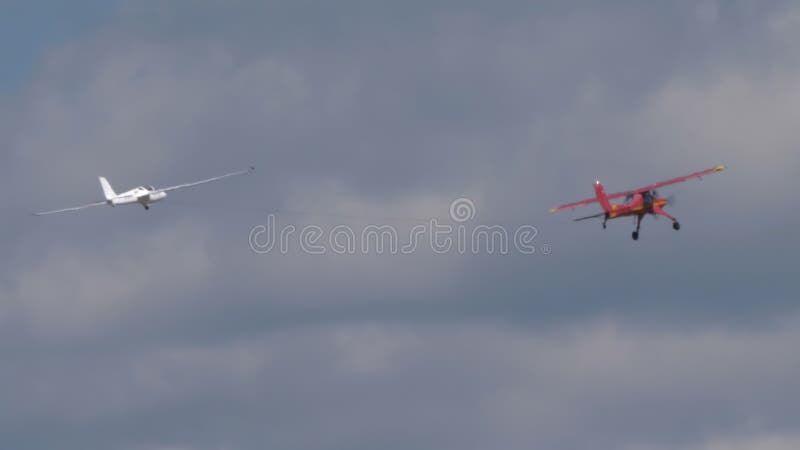 Red Small Sport Plane Flying in the Sky Pulls on a Rope the Glider ...