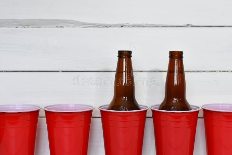 Red Plastic Drinking Cups and Two Beer Bottles Stock Image - Image of ...
