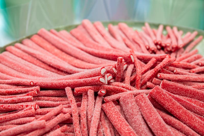 Red Sour Gummy Sticks Coated with Sugar in a Candy Store Stock Photo ...