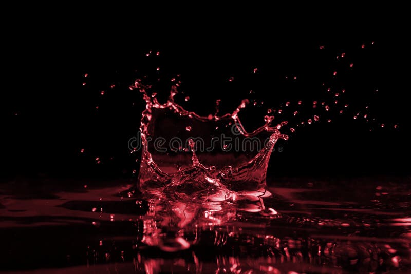 Red splash on a black stock image. Image of flowing - 107619681