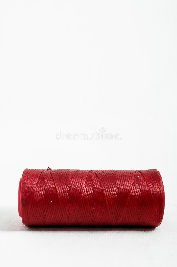 A Red Spool of Thread Sits on a White Background Stock Photo - Image of ...