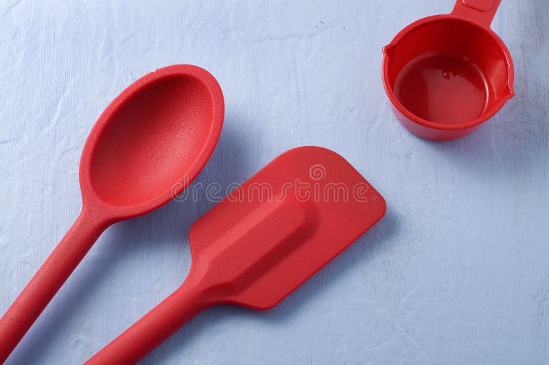 Red Spoon, Spatula and Measuring Cup on Blue Table Stock Photo - Image ...