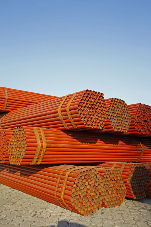 Red stacked steel pipe stock photo. Image of abstract - 224376824