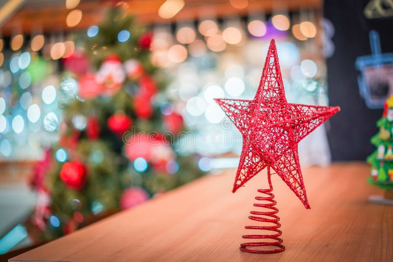 Red Star Decoration on the Wood Table with Blur Big Christmas Tree ...