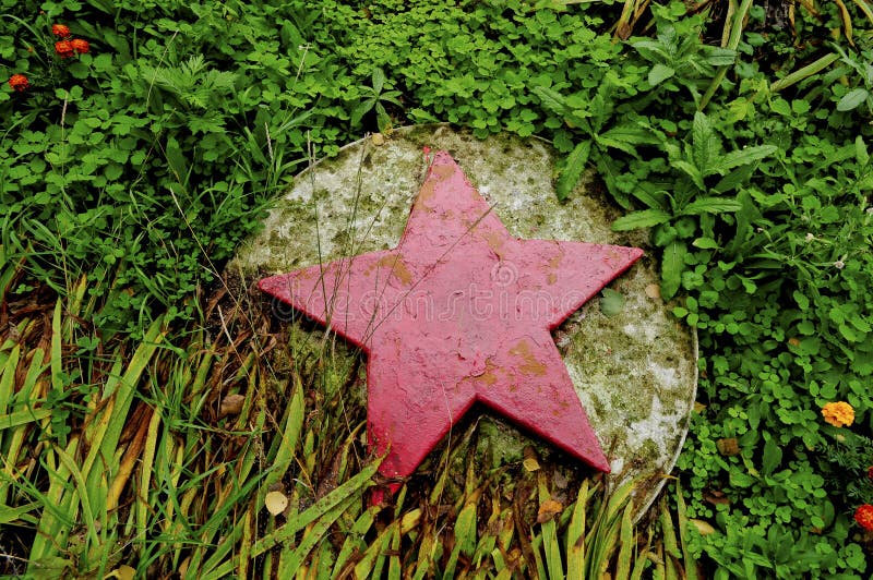 A red star in the grass. stock photo. Image of monument - 67603722