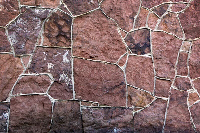 Red Stone Wall with Irregular Patterns and Textures. a Close-up of a ...