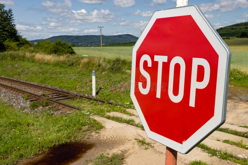 A Red STOP Sign before Crossing the Tracks Stock Image - Image of ...