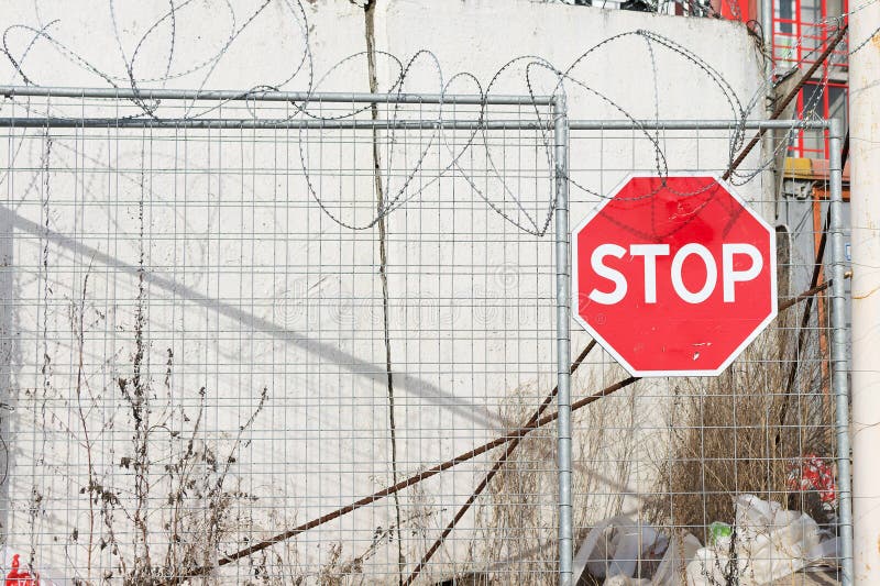 Red Stop Sign in Front of a Fence Stock Photo - Image of wire, object ...