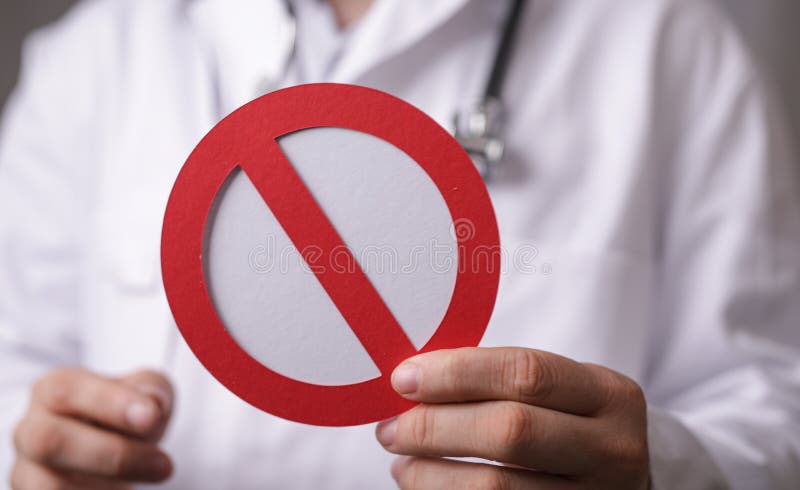 Red Stop Sign in the Hands of a Doctor Stock Photo - Image of hands ...
