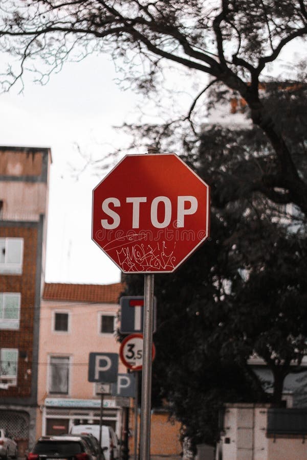 Red Stop Sign Positioned at the Side of a Paved Street Stock Photo ...