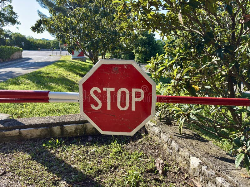 Red STOP Traffic Sign and Closed Barrier Gate Positioned in Front of ...
