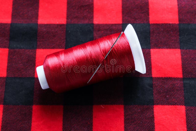 Red String with Needle on Colorful Fabric Stock Image - Image of object ...