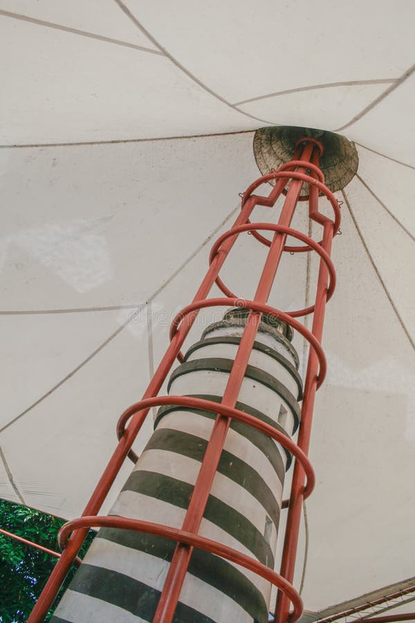 Red Striped Column Supporting White Umbrella in Outdoor Setting Stock ...