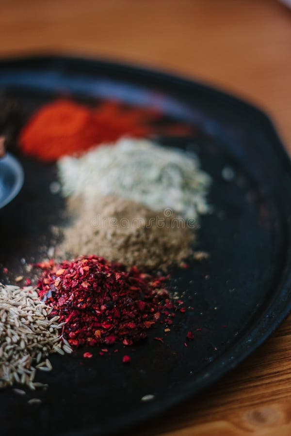 Red Sumac Spice on Black Metal Plate Surrounded by Other Spices. Stock ...