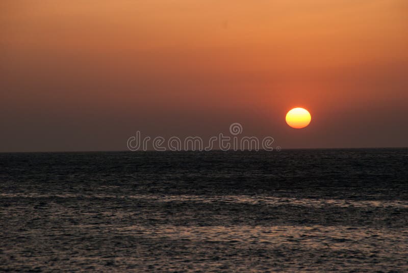 Red sun and sea at sunset stock photo. Image of horizon - 65673362