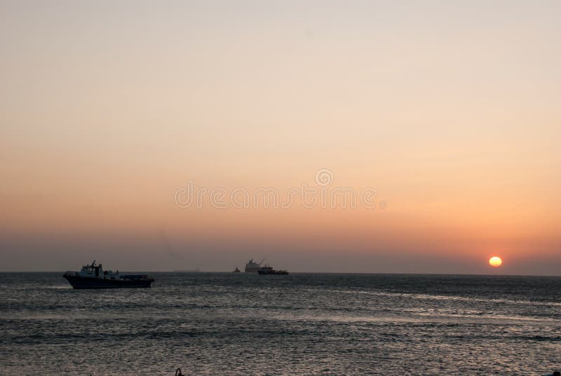 Red sun and sea at sunset stock image. Image of sunshine - 65673413