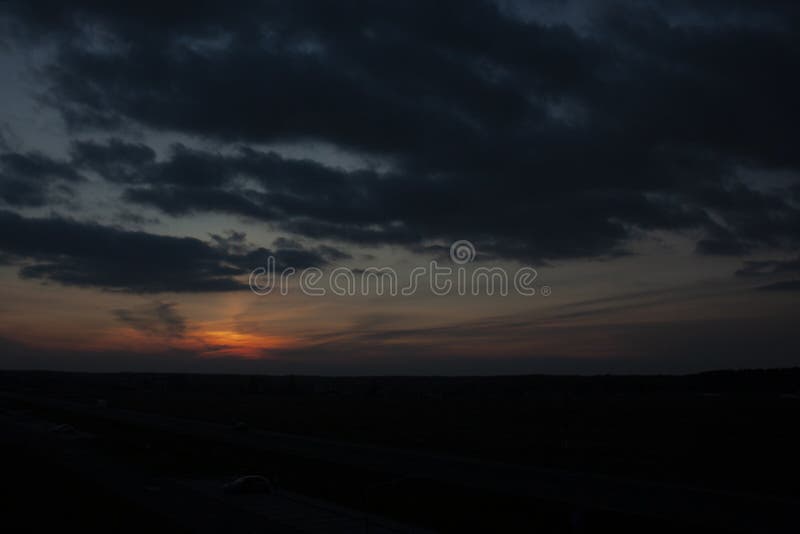 The Red Sun Set Below the Horizon. Beautiful Sunset and Cloudy Sky ...