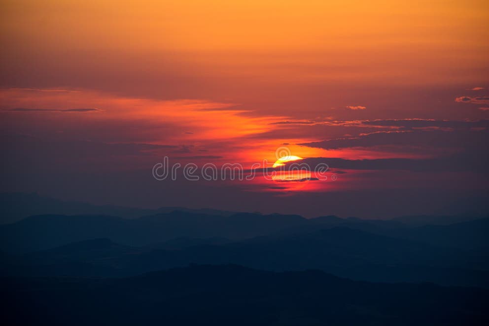 Red Sun Setting Behind Mountain and Making Clouds Red Stock Image ...