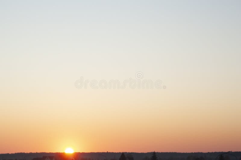 The Red Sun is Sinking Below the Horizon. Beautiful Sunset and Clear ...