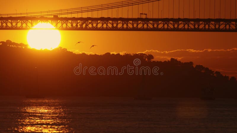 Red Sun - Sunset Behind Bridge Over Water Stock Video - Video of scenic ...