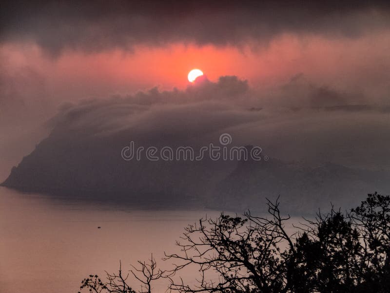 Red Sunset Over the Mountain Hiding in the Clouds Stock Image - Image ...