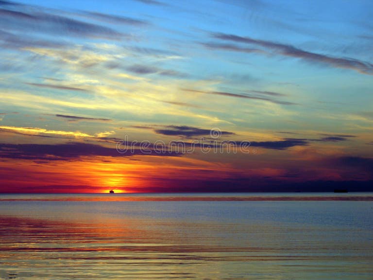 Red sunset over sea stock photo. Image of dramatic, ripples - 251884