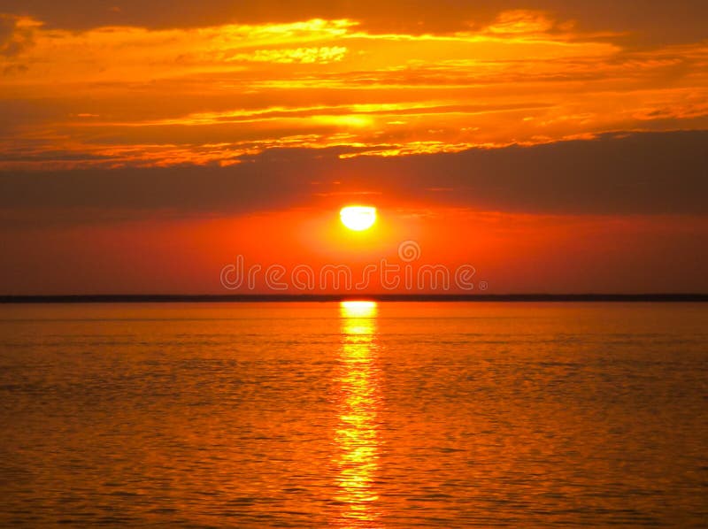 Red Sunset Over the Sea, Rich in Dark Clouds, Rays of Light Stock Photo ...