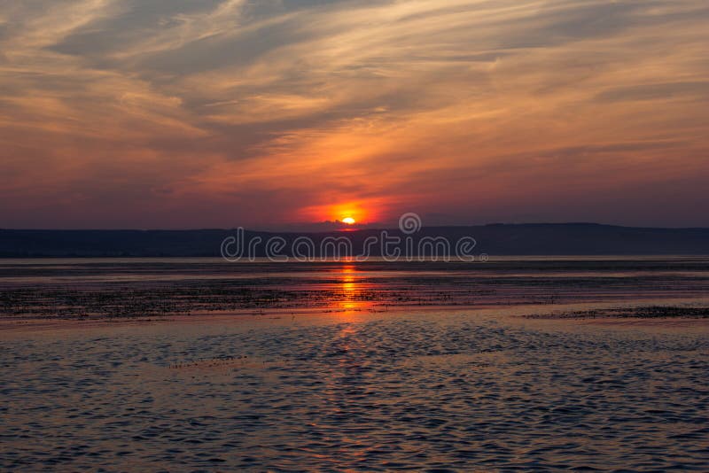 Red Sunset Over the Water. Dramatic Red Sunset. Sun Hiding Behind the ...