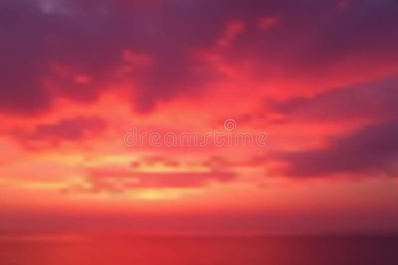 Red Sunset Sky Over the Sea with Scattered Clouds. Sun Shining Glow ...