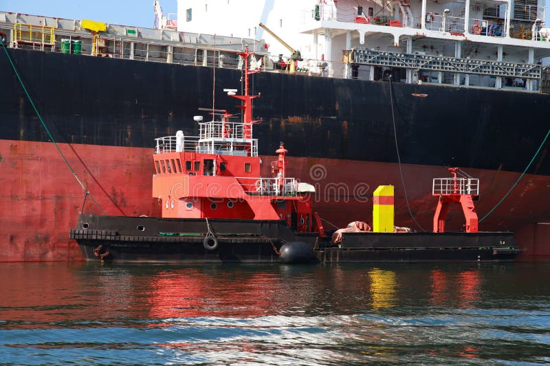 Red Support Tug and Big Cargo Ship Stock Image - Image of commercial ...