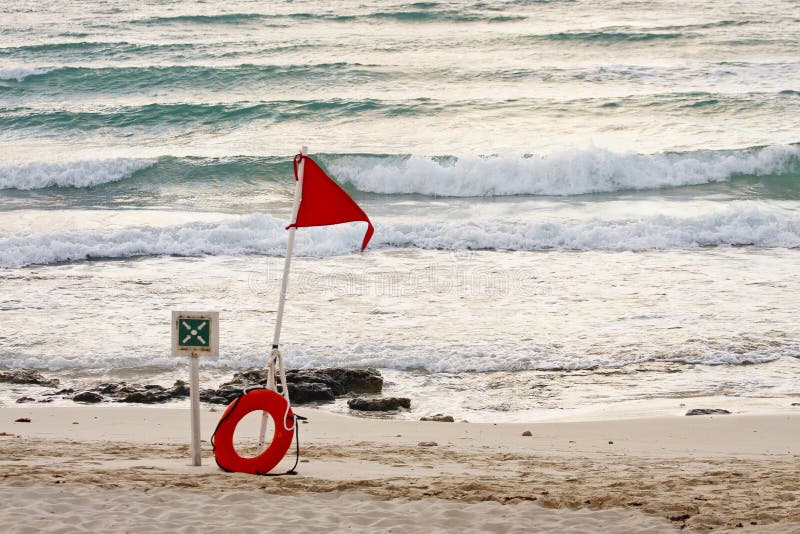 Red Surf Warning Flag and Life Ring on Beach Stock Image - Image of ...