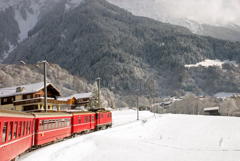 A Red Swiss Train Running through the Snow. Stock Image - Image of ...
