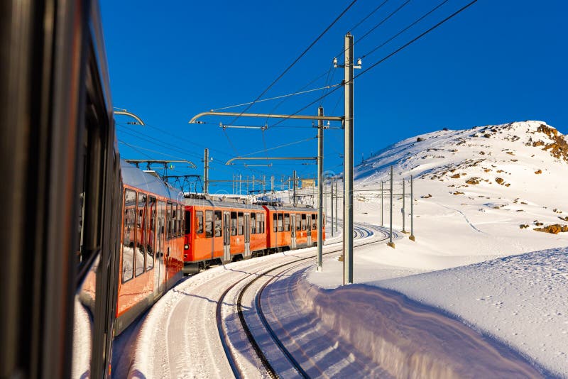 Red Swiss Train Running through Snow Stock Image - Image of power ...