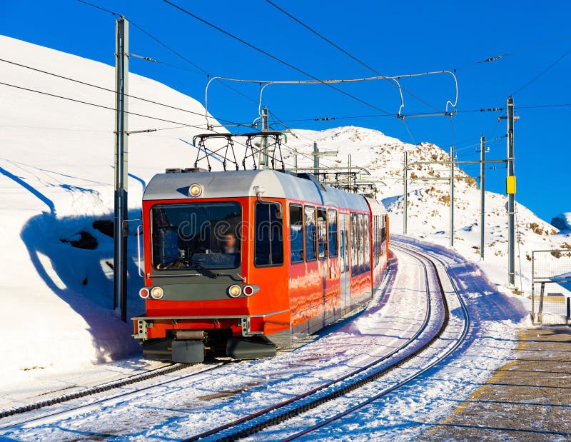 Red Swiss Train Running through Snow Stock Photo - Image of electric ...