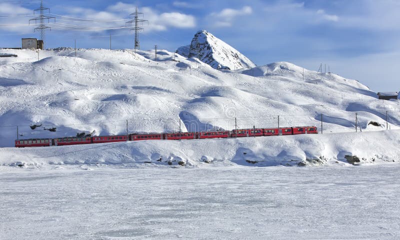 A Red Swiss Train Running through the Snow Stock Image - Image of ...