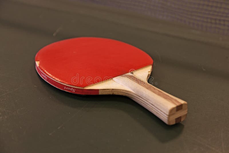 A Red Table Tennis Racket on a Green Ping Pong Table Stock Photo ...
